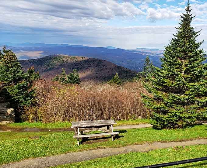 A picnic table overlooks layered mountain ranges, turning lunch into dinner theater with better views.