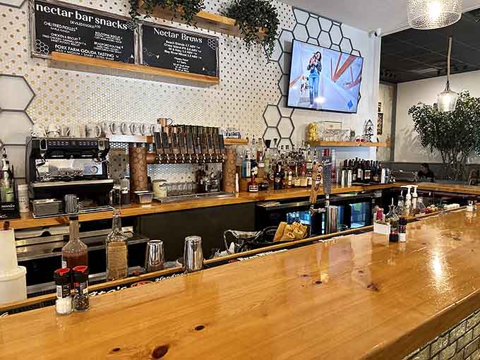 The bar area gleams with promise, featuring honeycomb accents that hint at the sweet experiences ahead.