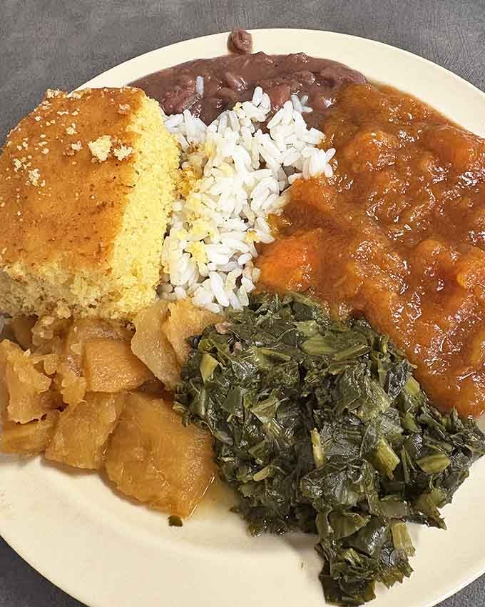 Cornbread, rice, greens, and savory sides come together on one plate like pure Southern comfort.