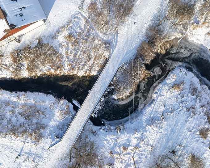 The Sugar River winds through winter landscapes, offering scenic trails for those seeking peaceful outdoor adventures.