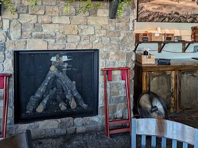 A stone fireplace adds rustic warmth, making this spot equally perfect for summer dinners and cozy winter meals.