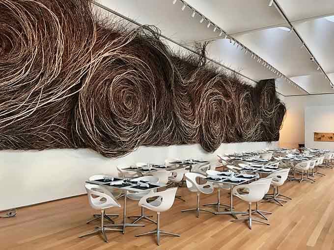 Modern dining meets massive wall art in a space where even your lunch break becomes an aesthetic experience worth savoring.