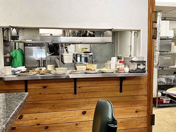 That kitchen window where breakfast magic happens and oversized pancakes begin their journey to your astonished table.