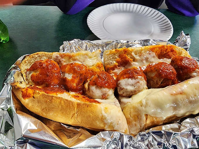 A meatball sub loaded with sauce and melted cheese, the kind of sandwich that requires strategic planning and possibly extra napkins.