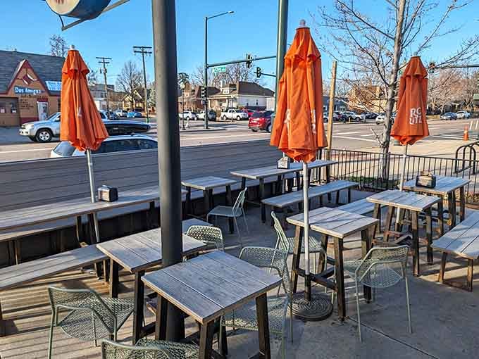 Orange umbrellas signal good times ahead at outdoor tables perfect for people-watching between magnificent bites.