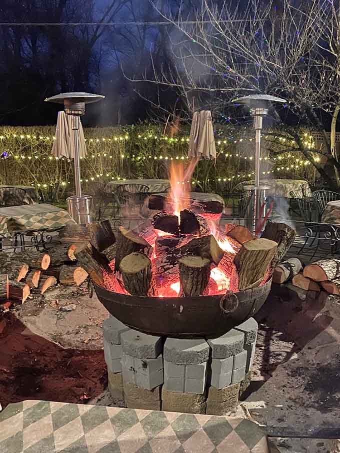 The outdoor fire pit glowing at twilight, creating ambiance that makes you want to cancel all your other plans.