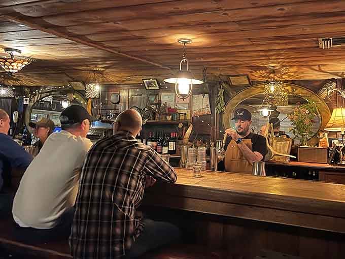 The bar area glows with warm lighting and rustic charm, inviting you to settle in for the long haul.