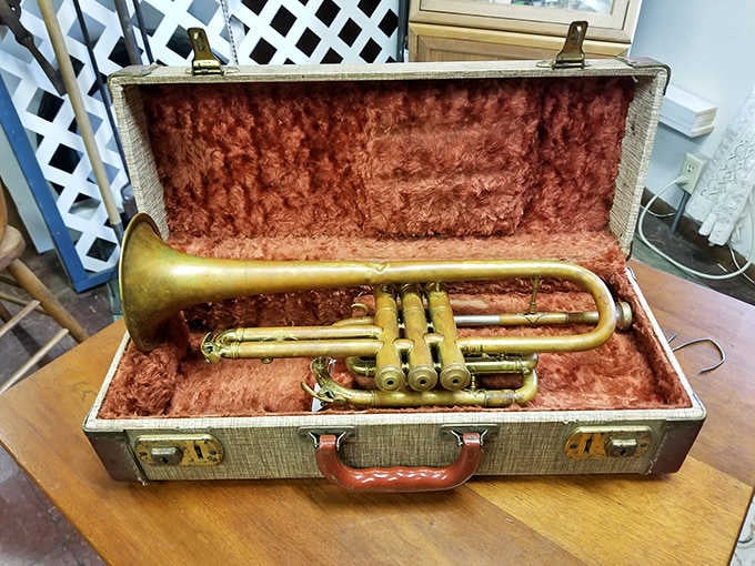 This brass cornet in its velvet-lined case once played jazz standards before television replaced live parlor entertainment.