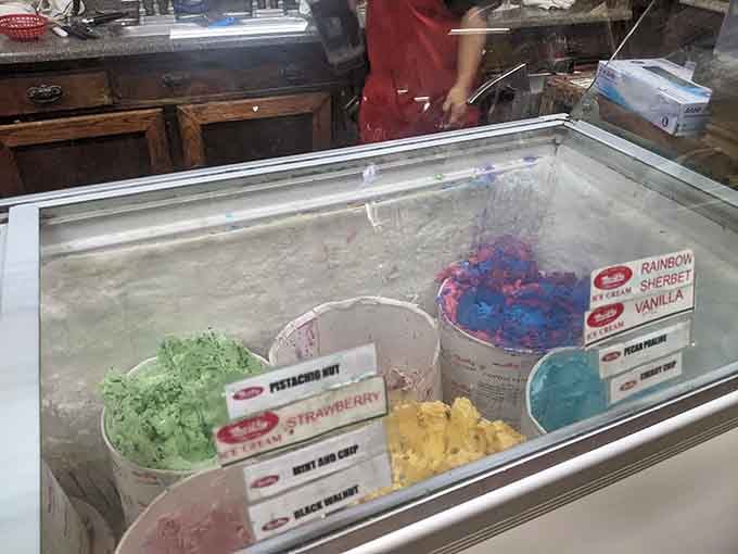 The ice cream case displays a rainbow of frozen flavors, each one more tempting than the last on a scorching day.