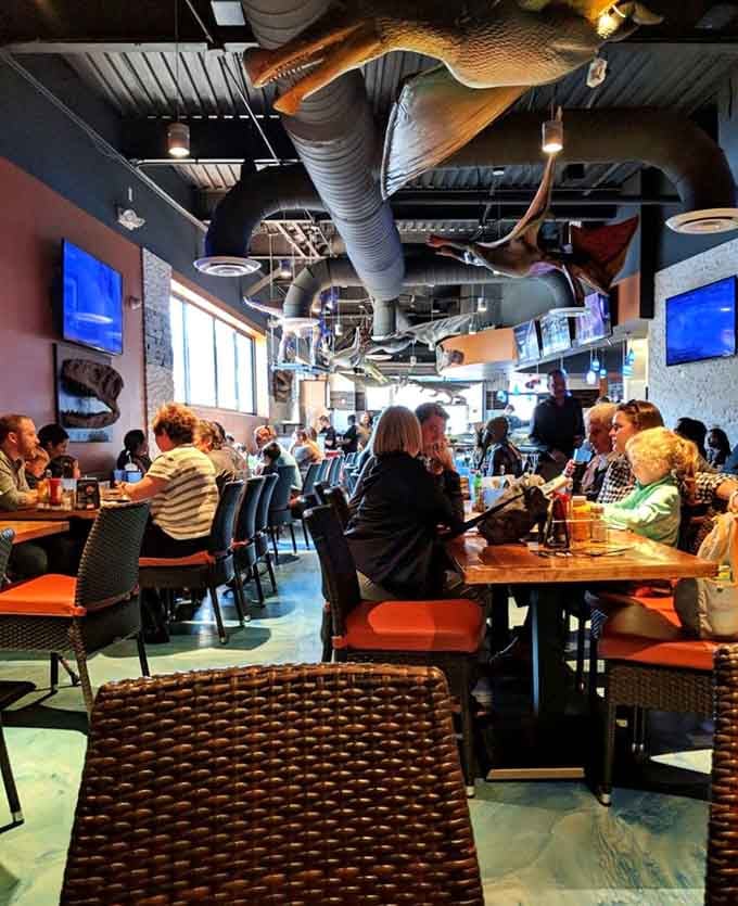 Happy diners surrounded by prehistoric decor, living their best Jurassic lives over lunch.