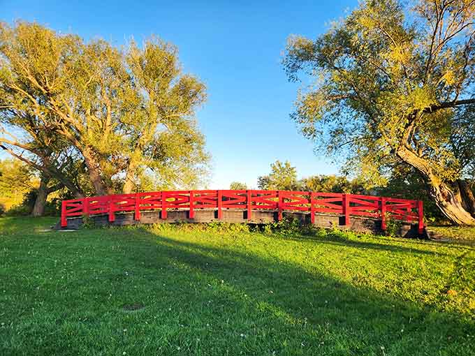 Red Bridge Park's iconic footbridge glows in golden hour light, a perfect photo opportunity and peaceful walking spot combined.