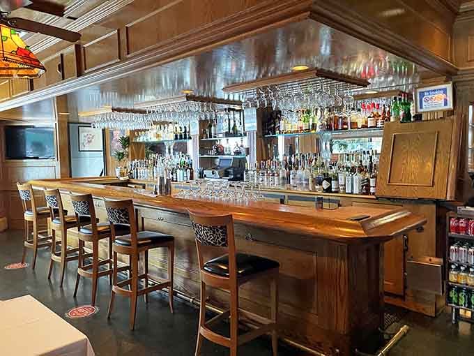 A classic bar setup with glassware hanging overhead, ready to pour whatever pairs perfectly with your meal.