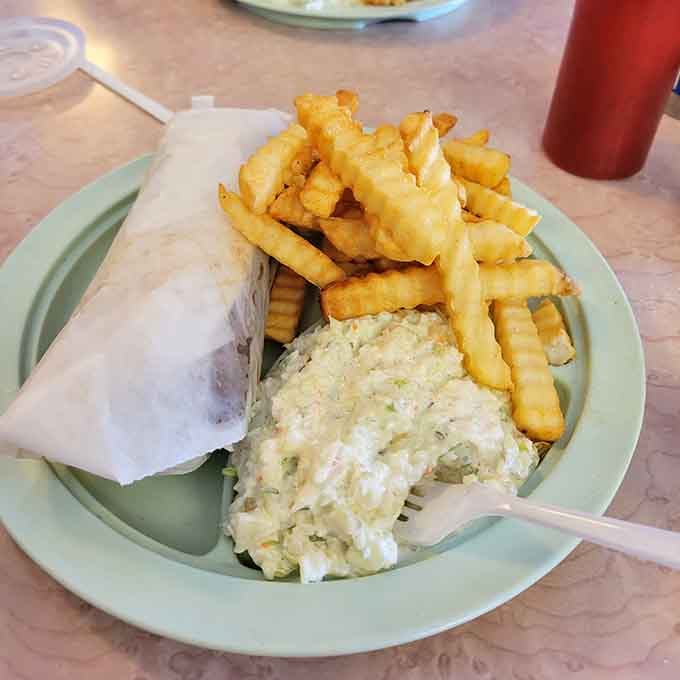 Those crinkle fries piled high next to coleslaw represent the kind of portion control that makes dietitians weep.