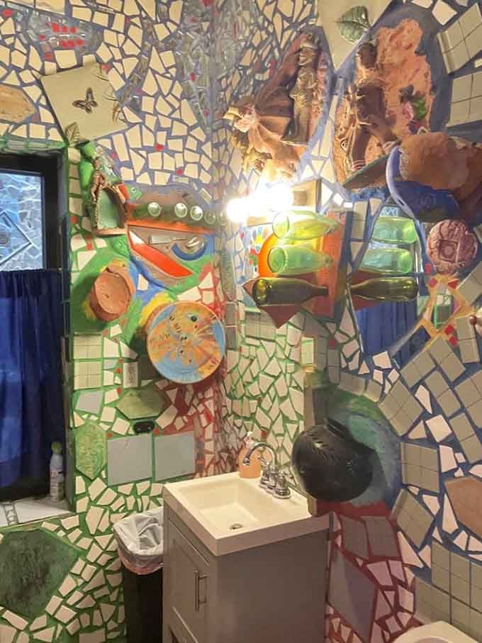 Even the restroom gets the full mosaic treatment here, proving no surface is too mundane for artistic transformation.