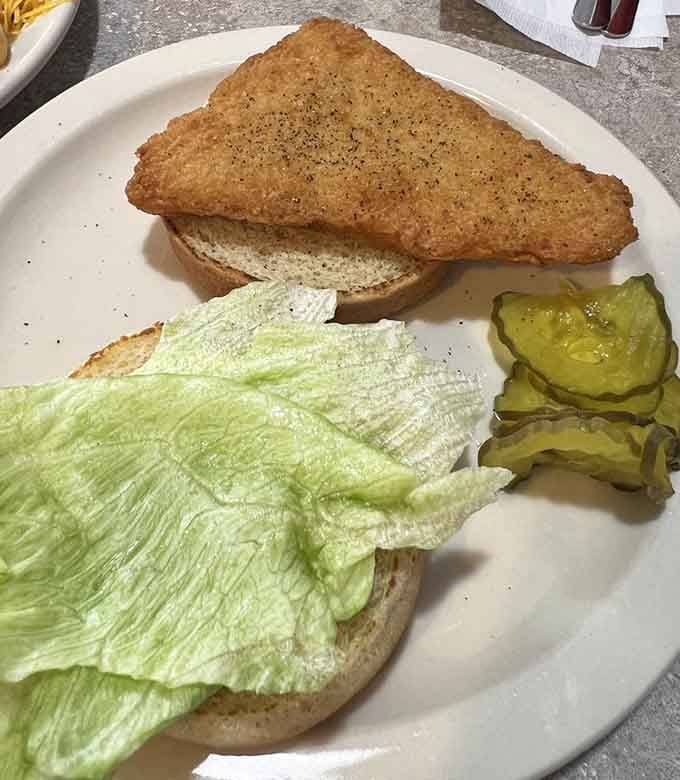 A perfectly golden fish sandwich proving this place can handle more than just their famous chili specialties with impressive skill.