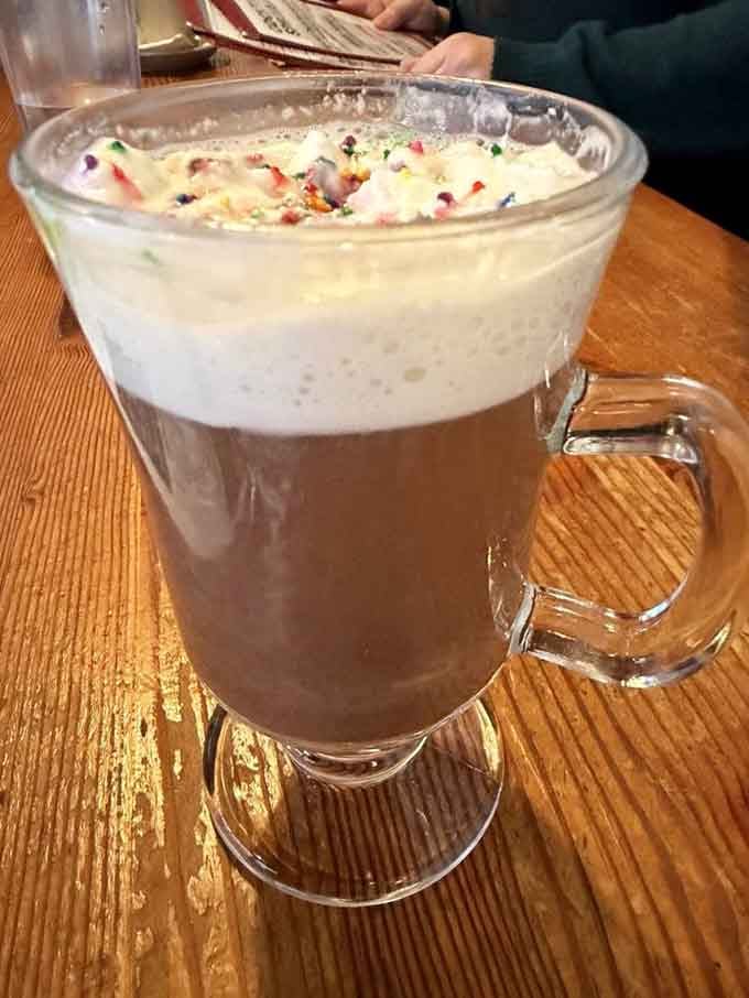 Hot chocolate topped with whipped cream and sprinkles, because even barbecue joints deserve a sweet side.