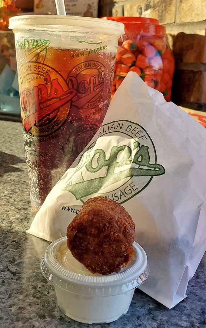 The branded cup and what appears to be a fried treat prove Pop's pays attention to every detail.