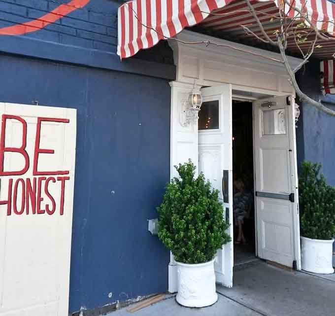 The entrance welcomes you with planters and charm, setting the tone for what's waiting inside those doors.
