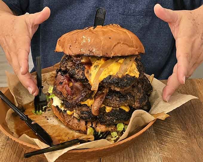 The Mighty Caveman burger stacks patties with reckless abandon, challenging both gravity and your jaw's maximum capacity.