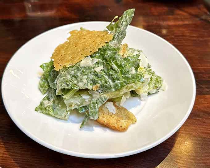 Caesar salad with crispy parmesan crisps, because pretending to eat healthy before pizza makes everything okay.