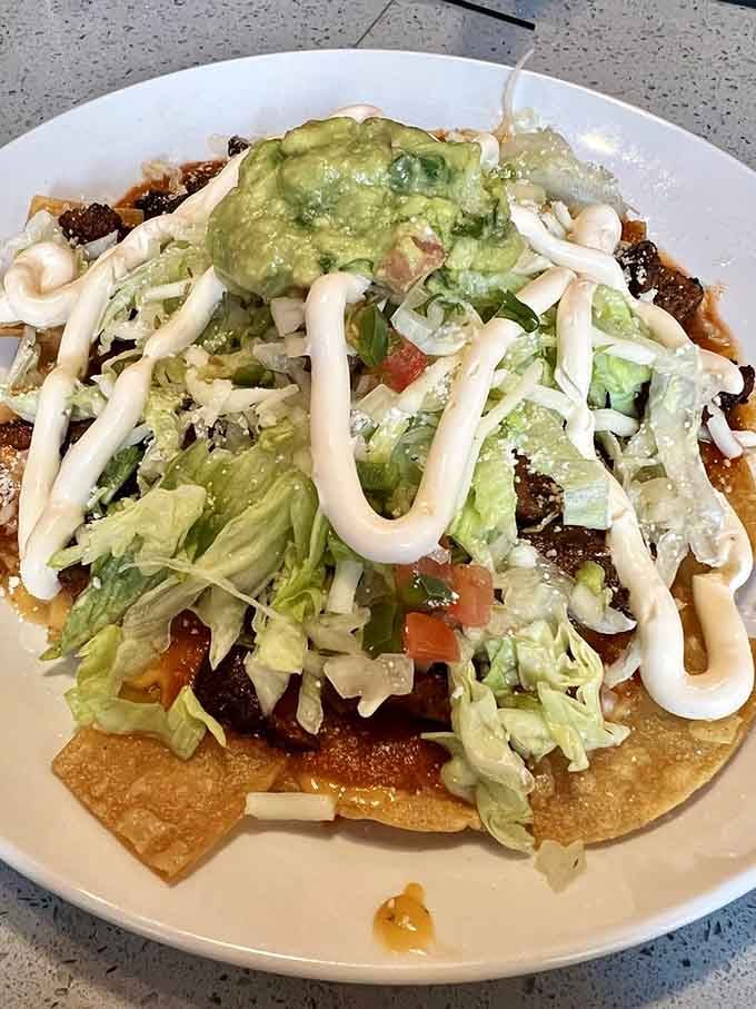 Nachos piled so high they defy physics, loaded with toppings that make sharing feel like an impossible task.