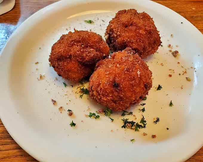Three golden fried spheres of joy that probably contain something delicious and definitely contain your future happiness.