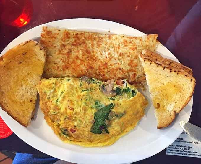 This veggie omelet stuffed with greens and cheese alongside golden hash browns makes eating your vegetables feel less like a chore.