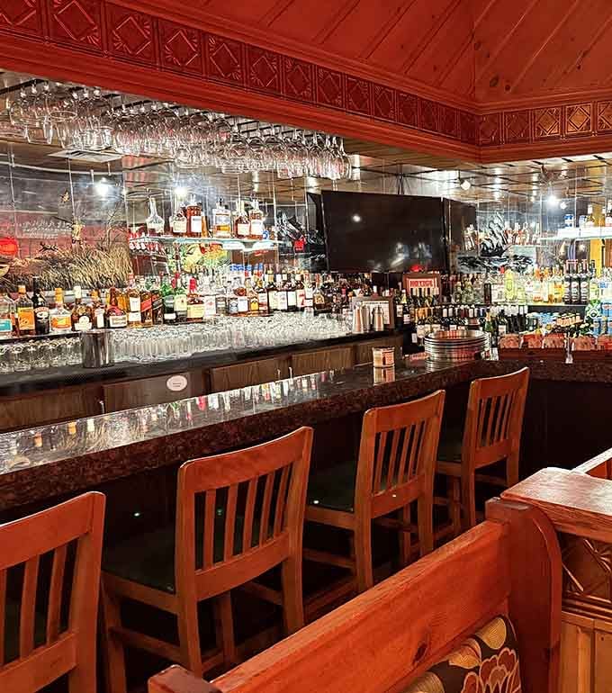 A well-stocked bar area with enough glassware overhead to make you wonder if they're expecting quite the party.