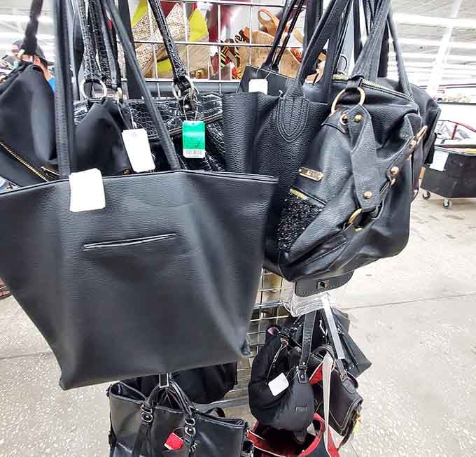 Handbags hanging like art in a gallery, each one ready to carry someone's essentials in style.