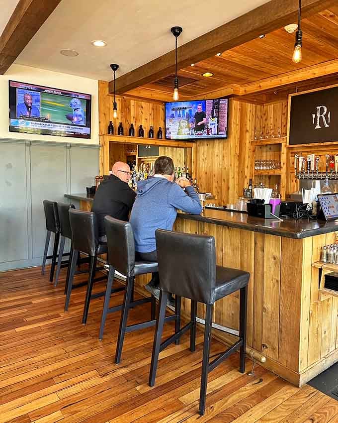 The bar area features warm wood tones and comfortable seating for pre-meal drinks or post-brunch relaxation.