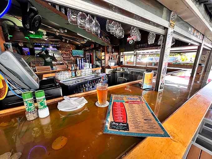 The bar stretches invitingly, ready to serve cold drinks while you contemplate your inevitable grouper sandwich order.