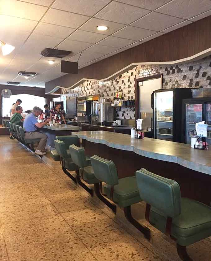 The classic counter seating invites solo diners to settle in, order up, and watch the kitchen magic unfold.