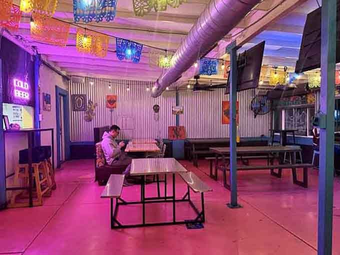 Pink and purple lighting transforms casual dining into something festive, fun, and totally Instagram-worthy without trying.