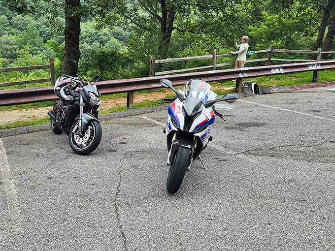 Pull over at designated spots where motorcyclists gather to admire views that justify every twist and turn.