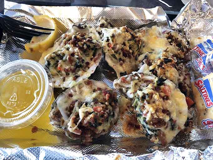 Oysters Rockefeller looking like they're ready for their close-up, bubbling with cheese and spinach in all the right ways.