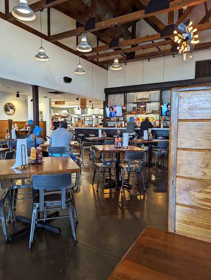 High ceilings with exposed beams and pendant lights create an airy, welcoming space for serious barbecue consumption.