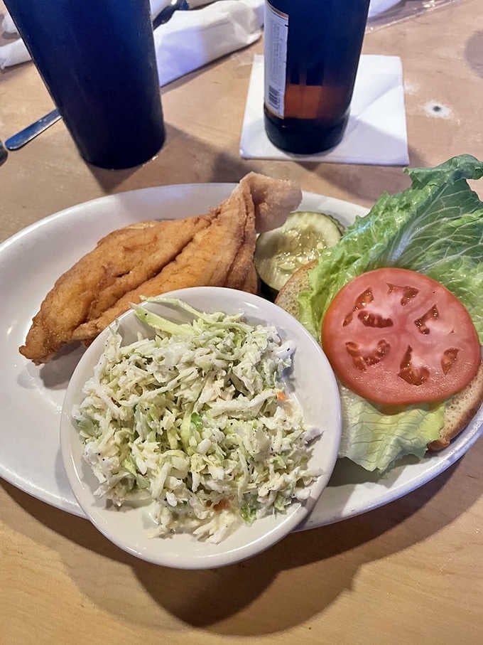 Fried fish sandwich with crisp lettuce and tomato, the kind of lunch that makes you forget about everything else.