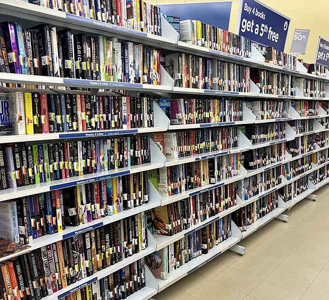 Books stacked floor to ceiling like a library decided to have a clearance sale and forgot to stop ordering inventory.
