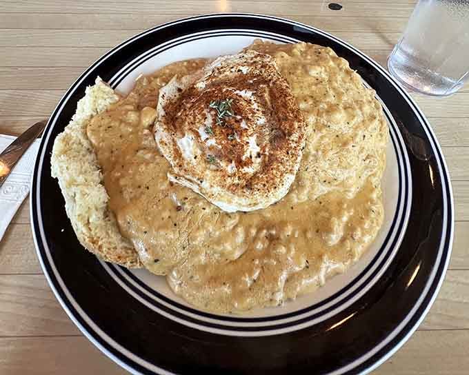 A towering biscuit sandwich that requires both hands and zero shame, stacked high with everything that makes mornings worth facing.