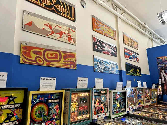 Colorful backglass art decorating the walls proves pinball machines are basically playable pop art you can touch.