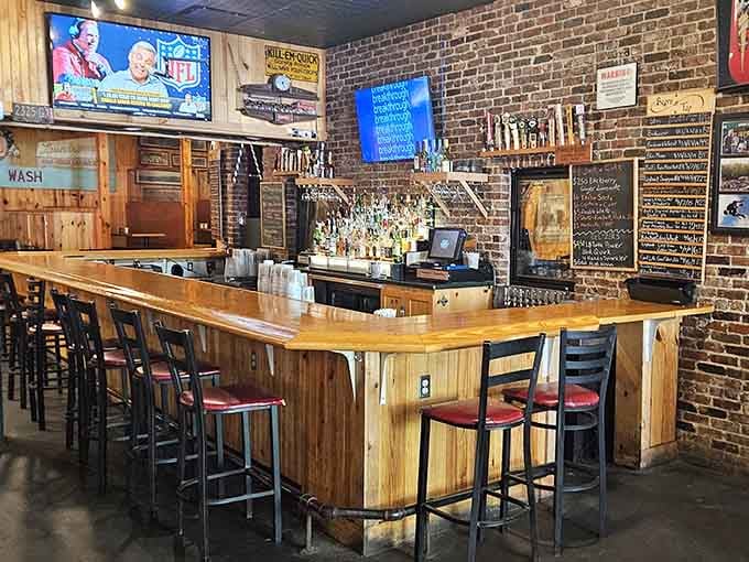 The bar area showcases an impressive tap selection, because great pizza deserves equally great beverage companions.