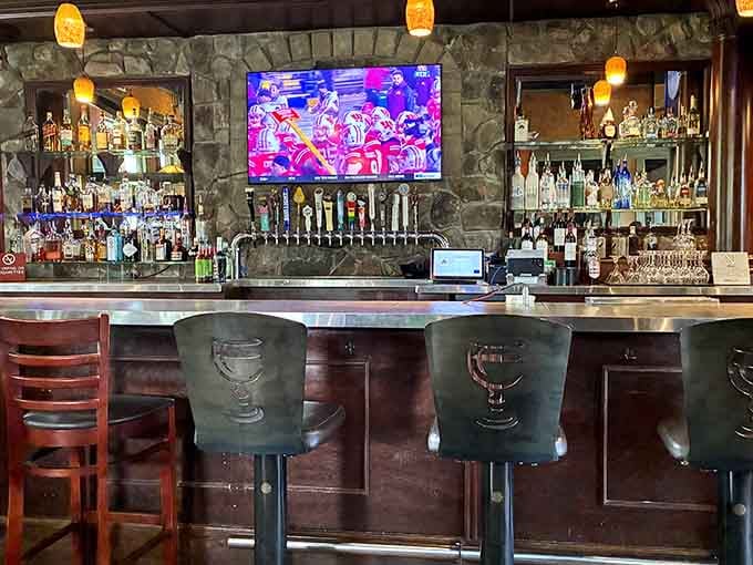 The bar area features an impressive selection of craft beers and cocktails for adults who earned their pizza honestly.