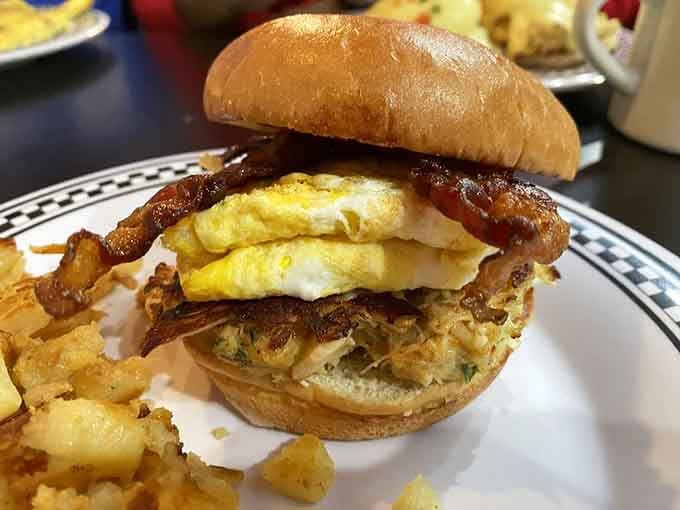 The Eastern Shore sandwich stacks crab cake with eggs and bacon, creating Maryland's answer to breakfast architecture at its finest.