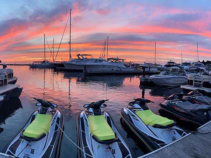 The marina at dusk paints the sky in cotton candy colors, while boats rest peacefully after a day on the water.