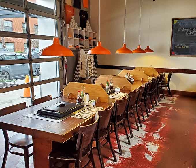 Those orange pendant lights hanging over griddle-equipped tables set the stage for interactive breakfast theater at its finest.