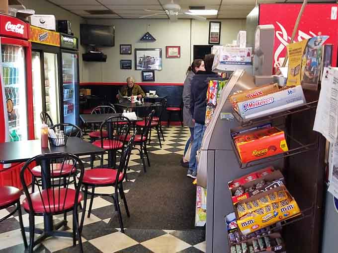 Red accents and black tables create a cozy spot where regulars gather for their daily ritual.