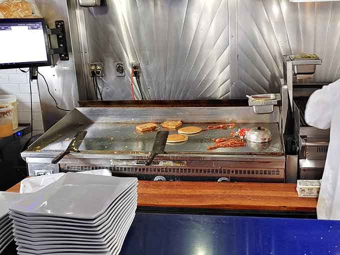 The open griddle where breakfast magic happens in full view, sizzling and popping like a delicious symphony for your senses.