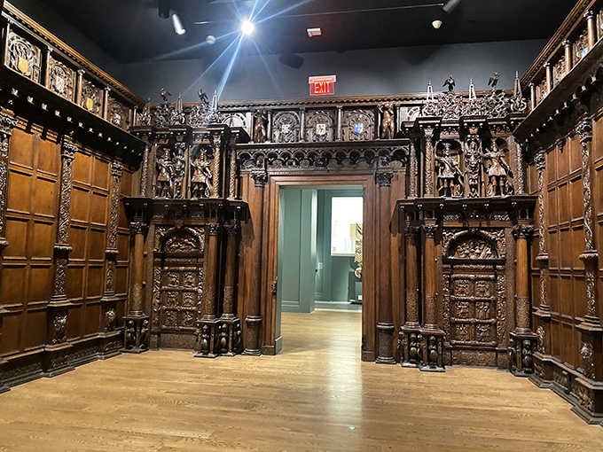 This ornately carved wooden room feels like stepping through a portal into an English manor house library.