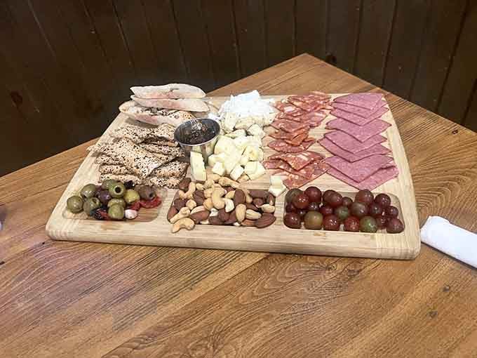 A charcuterie board loaded with meats, cheeses, and accompaniments, perfect for sharing or not, we won't judge.