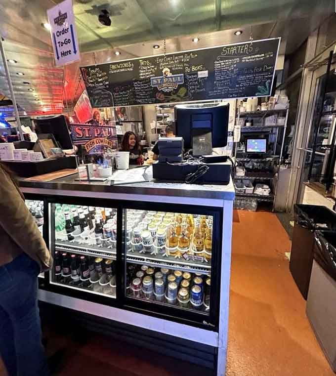 The counter area where magic happens, complete with beverages and friendly faces ready to serve your seafood dreams.